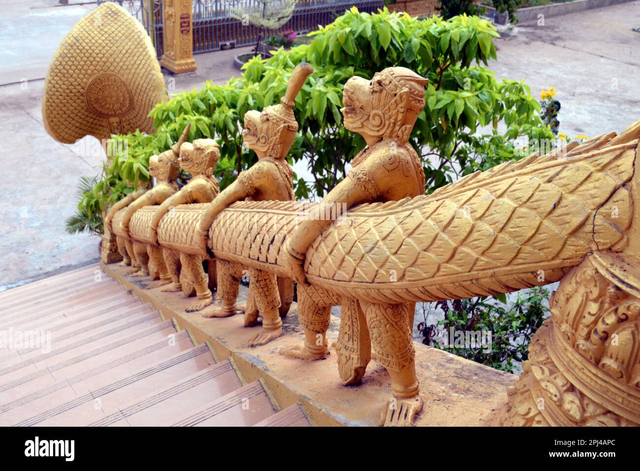 Cambodia, Phnom Penh: monkeys supporting a golden naga which guards the ...