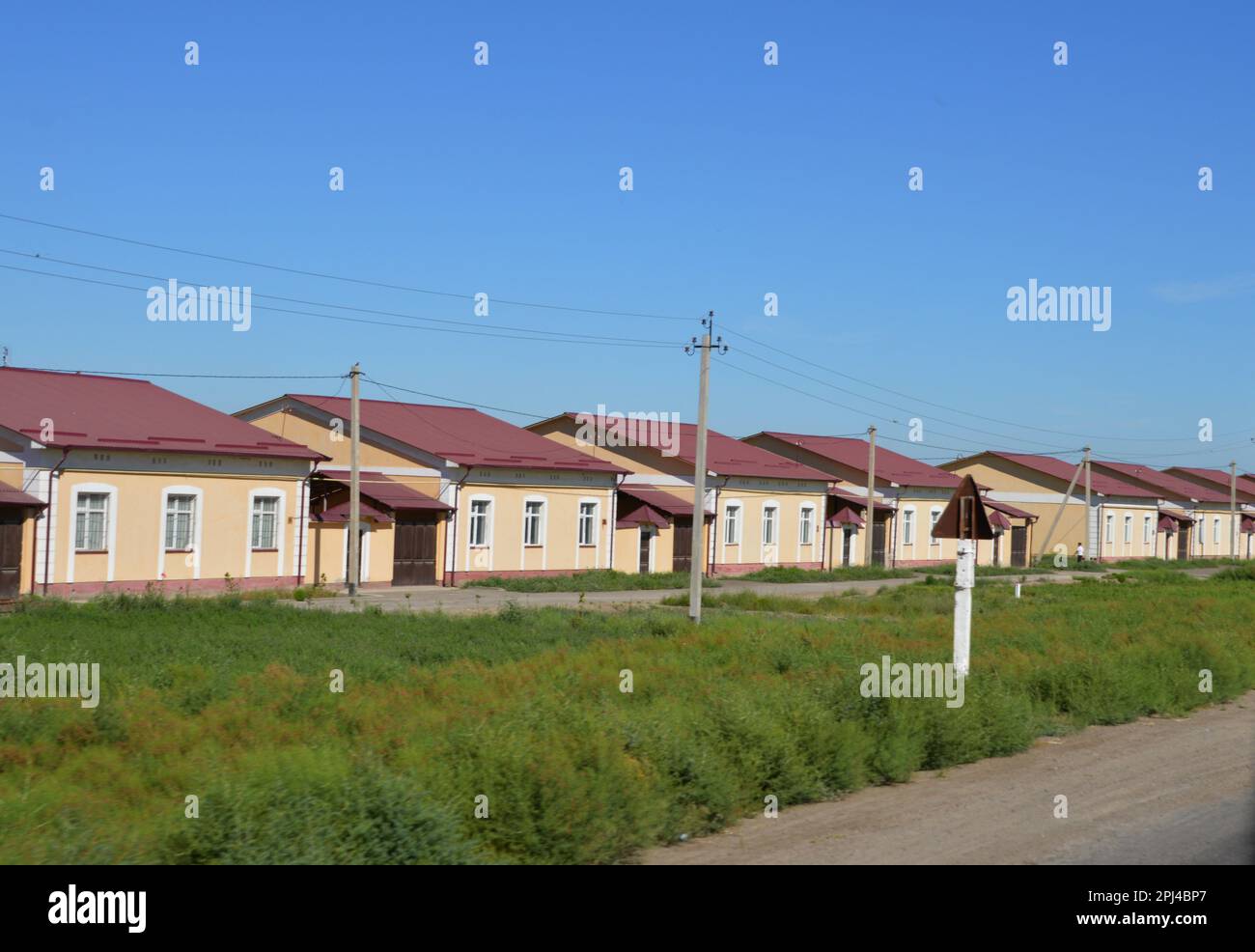 Uzbekistan, Bukhara: standard pattern housing lines the roads in large ...