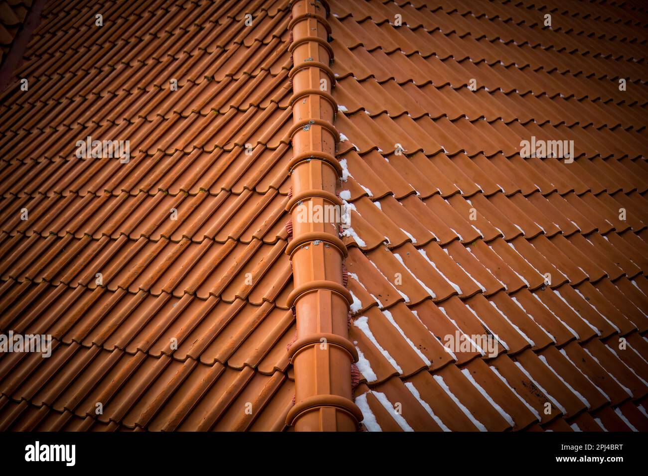 Closeup of house roof top covered with ceramic shingles. Tiled covering ...
