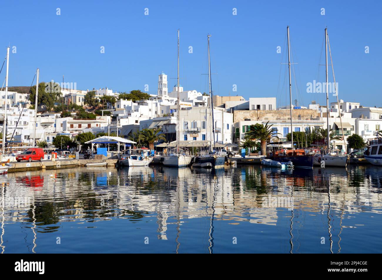 Greece, Island of Milos: the port of Adamas, reflected in the waters of ...