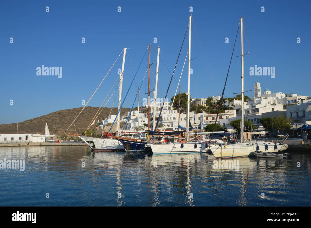 Greece, Island of Milos: yachts in the harbour of Adamas, reflected in ...
