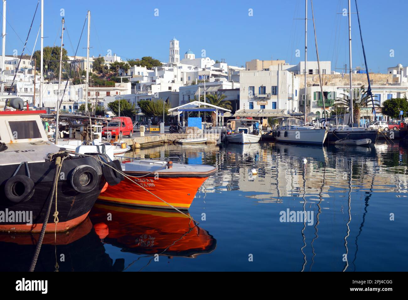 Greece, Island of Milos: the port of Adamas, reflected in the waters of ...