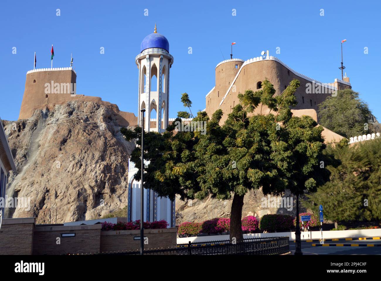 Oman, Muscat: minaret of the blue-tiled Al Khor Mosque, with the ...