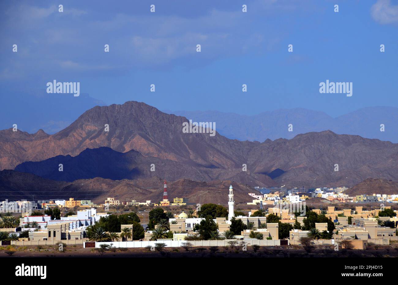 Oman, Jabrin: view of the town, at the foot of barren mountains, from ...