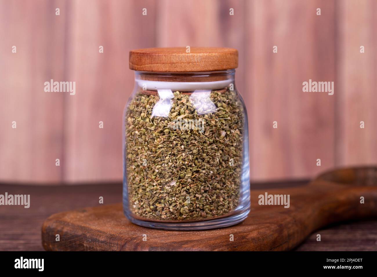 Thyme spice. Dried Thyme leaf in glass jar on wood background. Spice ...