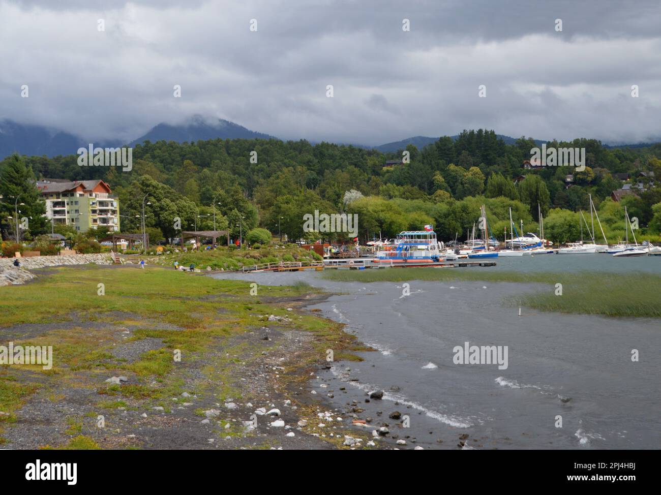 Chile. Pucon: the beach and yacht harbour in a bay on Lake Villarrica ...