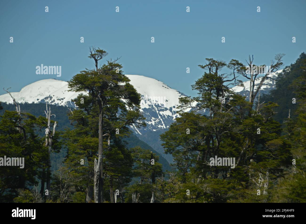 Chile. Chaiten: snow-covered mountain peaks of the Andes with part of ...