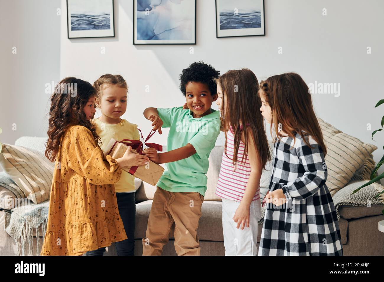 At home. Children on celebrating birthday party indoors have fun ...