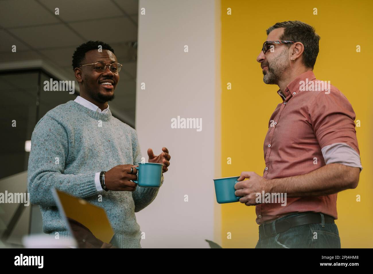 A Caucasian business person listening to his colleague explaining ...