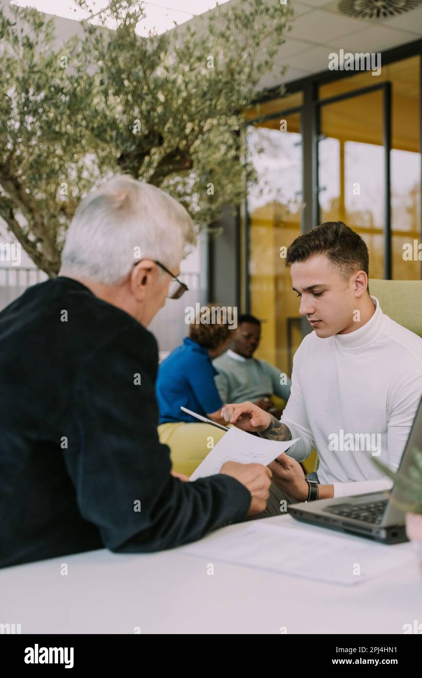 Two business colleagues talking and discussing about the new upcoming ...