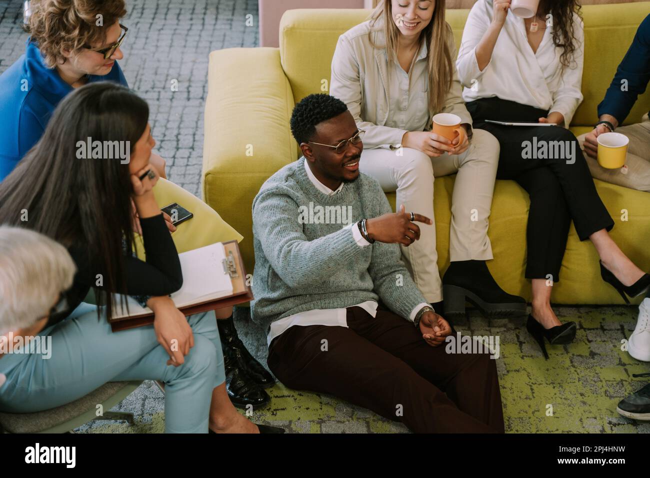 A group of business people having a conversation at the office. Black ...
