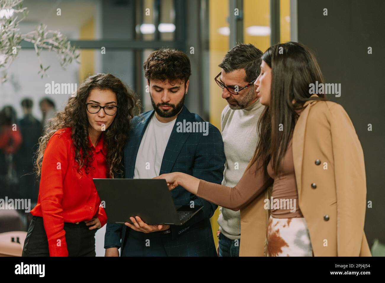 Sales discussion between three young and one middle-aged coworkers ...