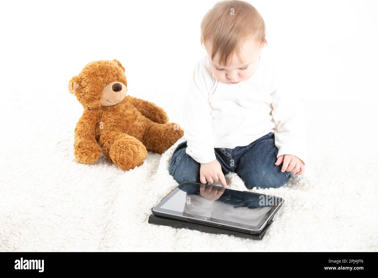 Stock studio photo with a white background of a baby looking at the ...
