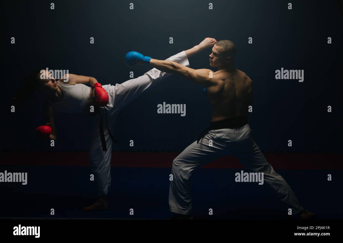 Two good looking karate friends doing the Mawashi Geri practice at the ...