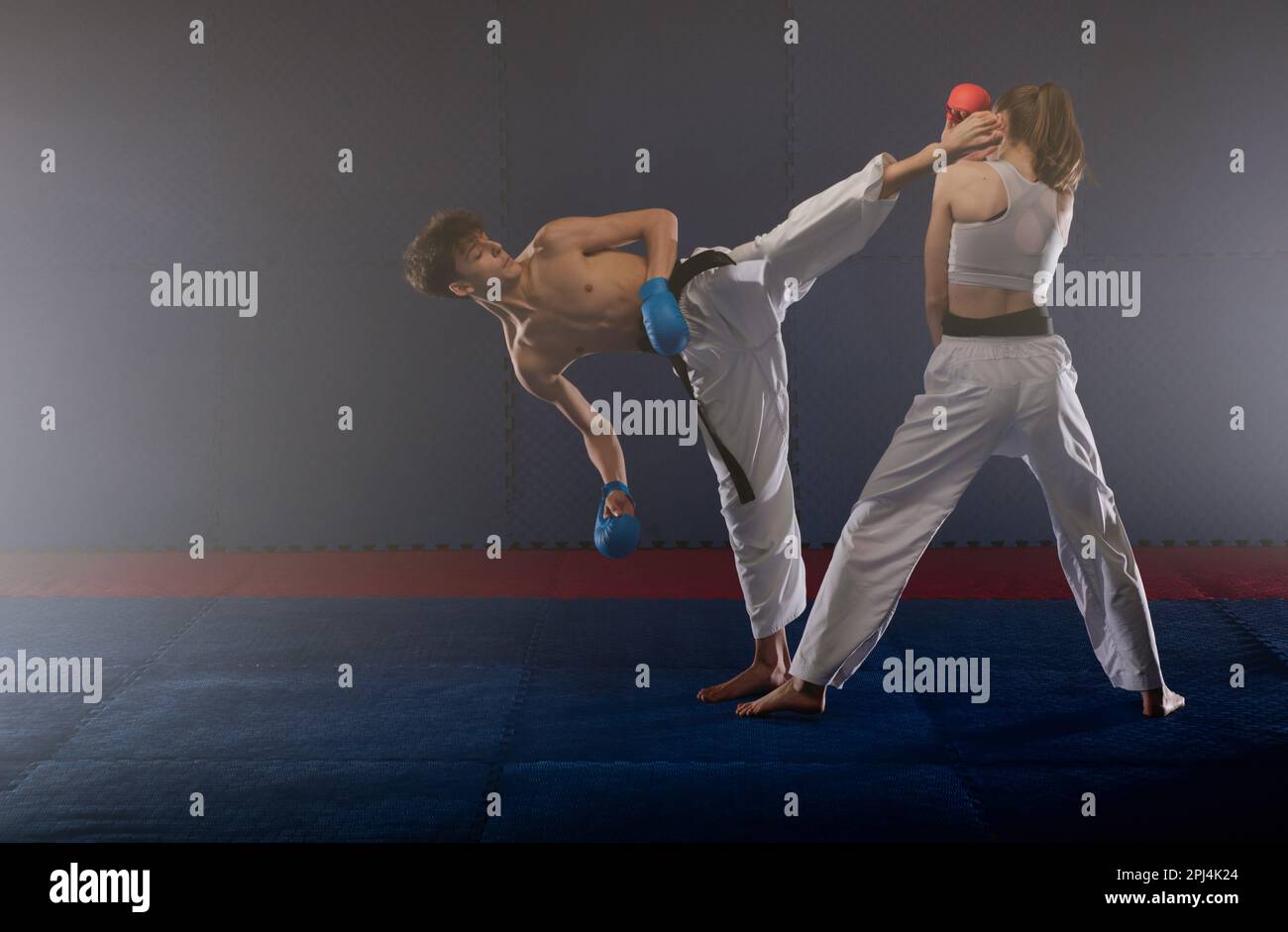 Close up of two young karate friends doing the Mawashi Geri pose at the ...