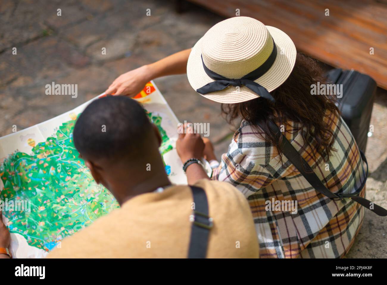 A lovely girlfriend is pointing on the map to help her confused ...