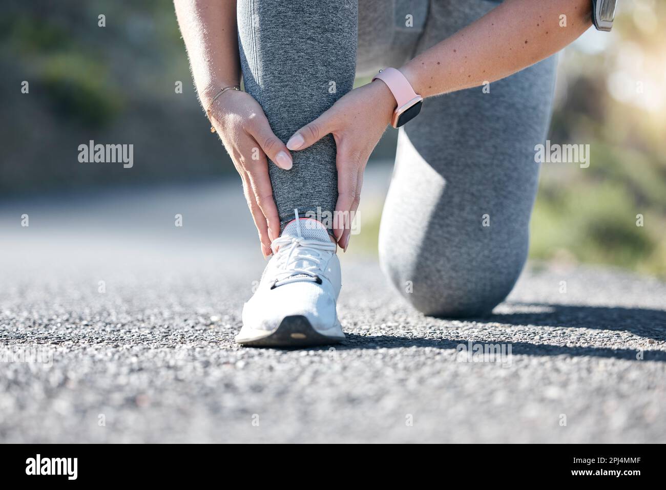 Running, fitness and ankle injury with a woman on the street during a ...