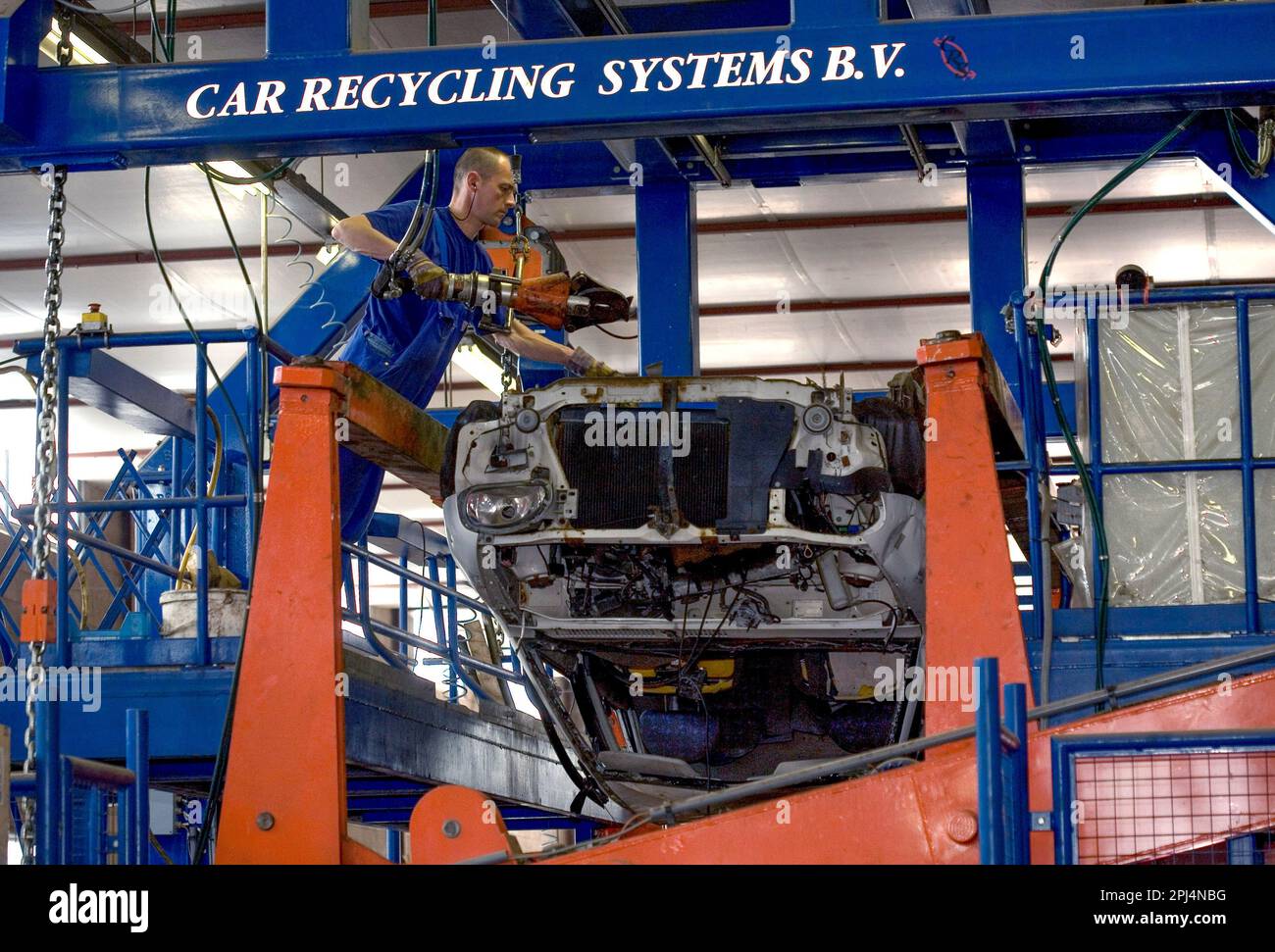 Car crusher on a scrapyard to recycle cars - Netherlands. vvbvanbree ...