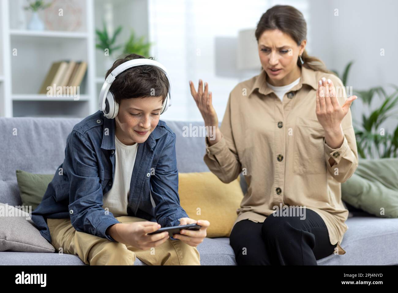 Family conflict quarrel, woman mother quarrels with son, teenage boy in ...