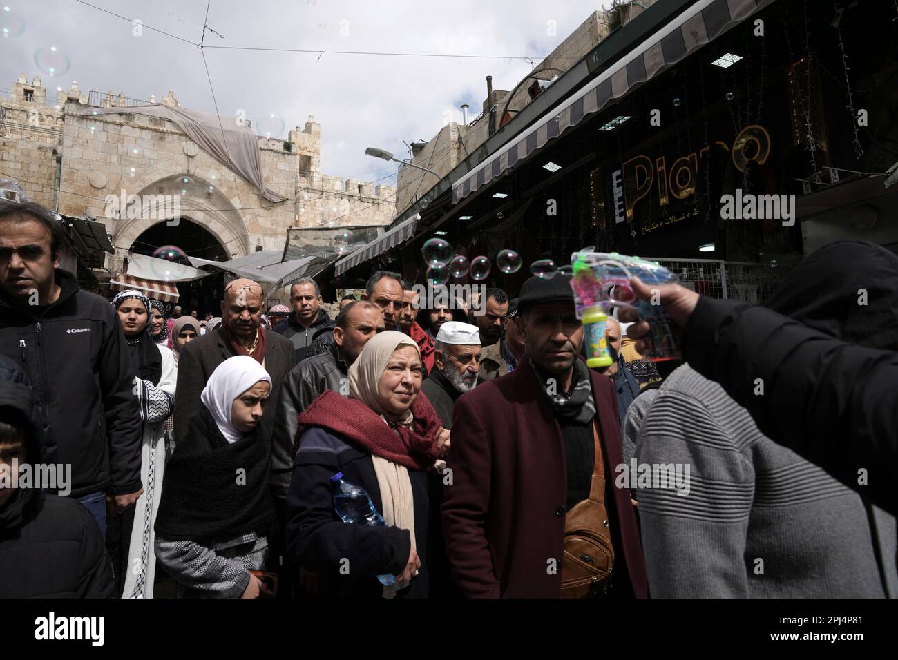 Palestinians walk from the Damascus Gate on their way to Friday prayers ...