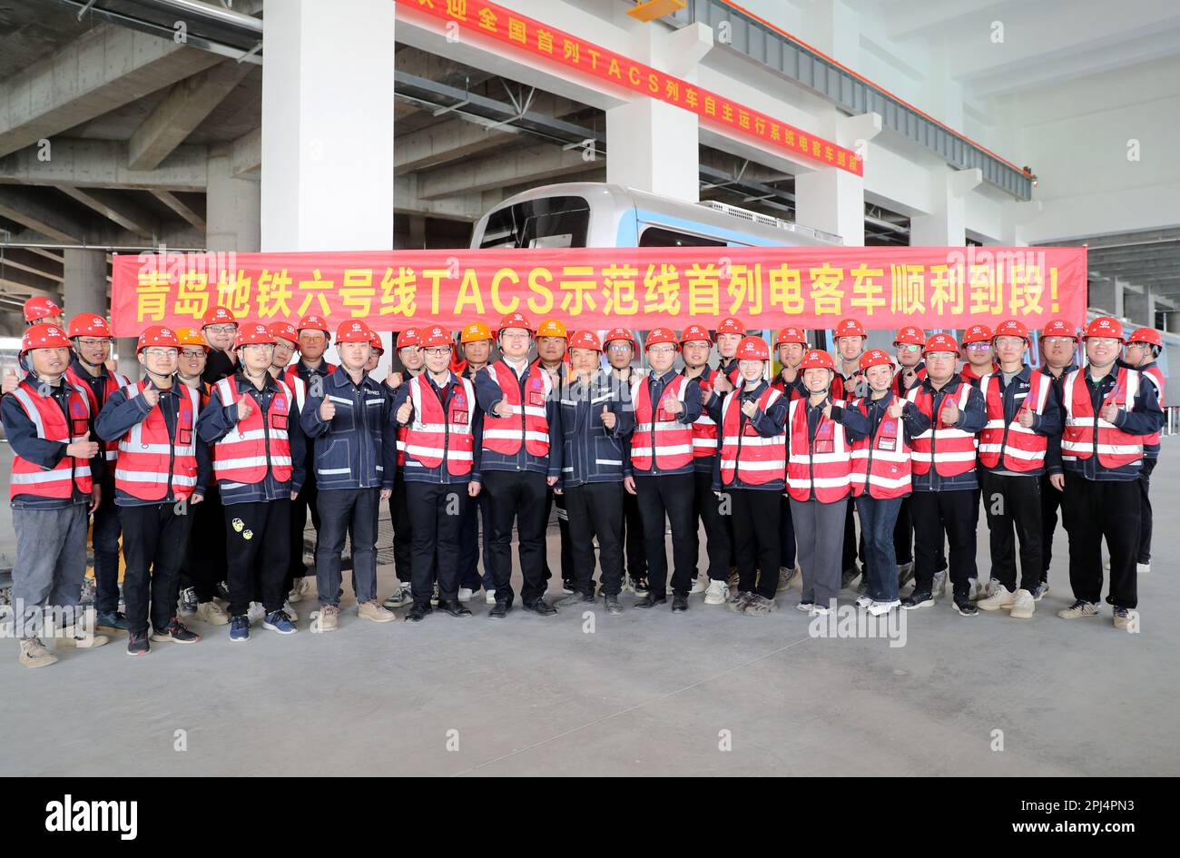 QINGDAO, CHINA - MARCH 31, 2023 - Builders pose for a group photo in ...