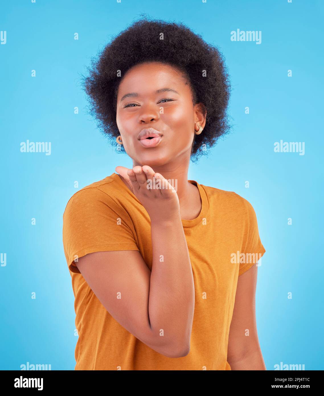Portrait, black woman and blowing kiss on blue background of love, care ...