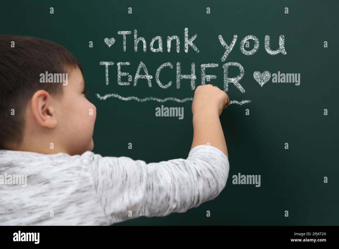 Cute little boy written phrase Thank You Teacher on green chalkboard ...