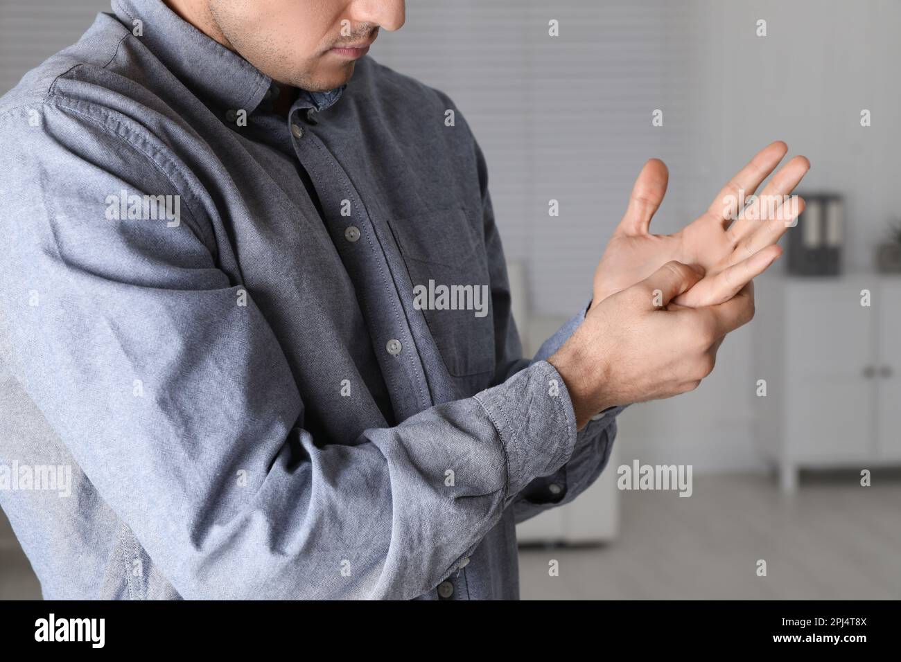 Man suffering from trigger finger at home, closeup Stock Photo - Alamy