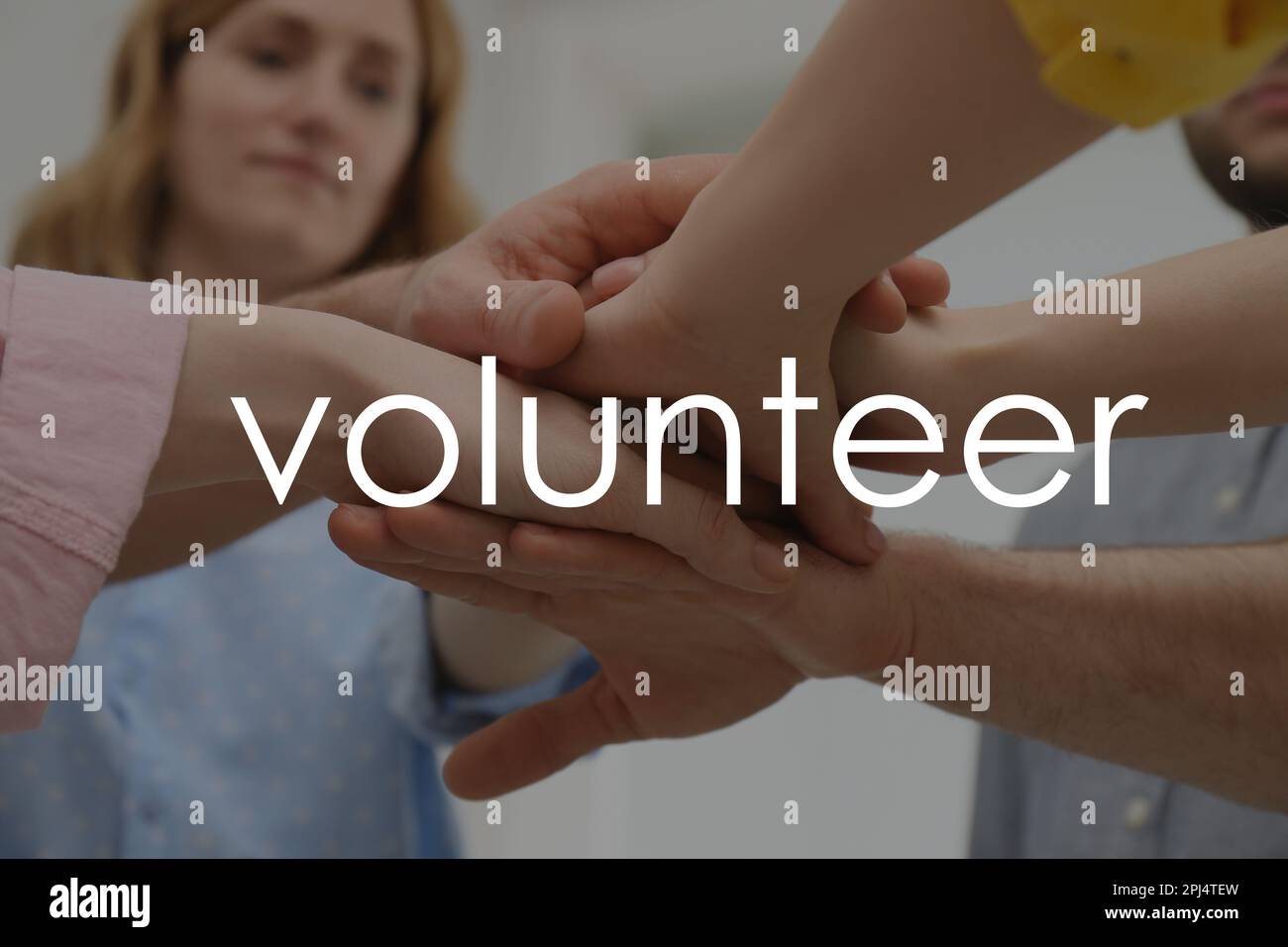 Group volunteers putting hands hi-res stock photography and images - Alamy