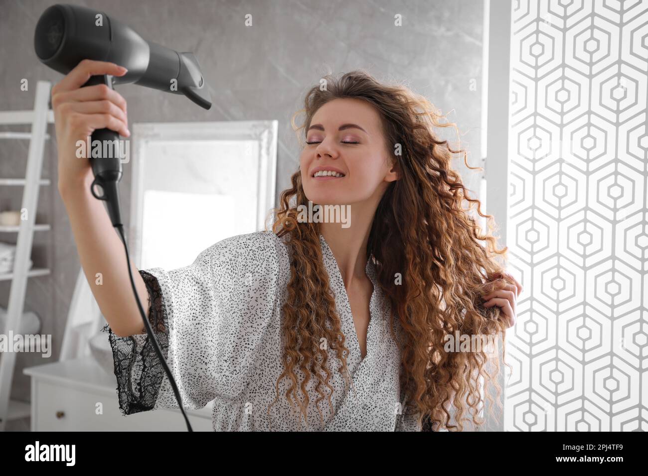 Woman with hair dryer hi-res stock photography and images - Alamy