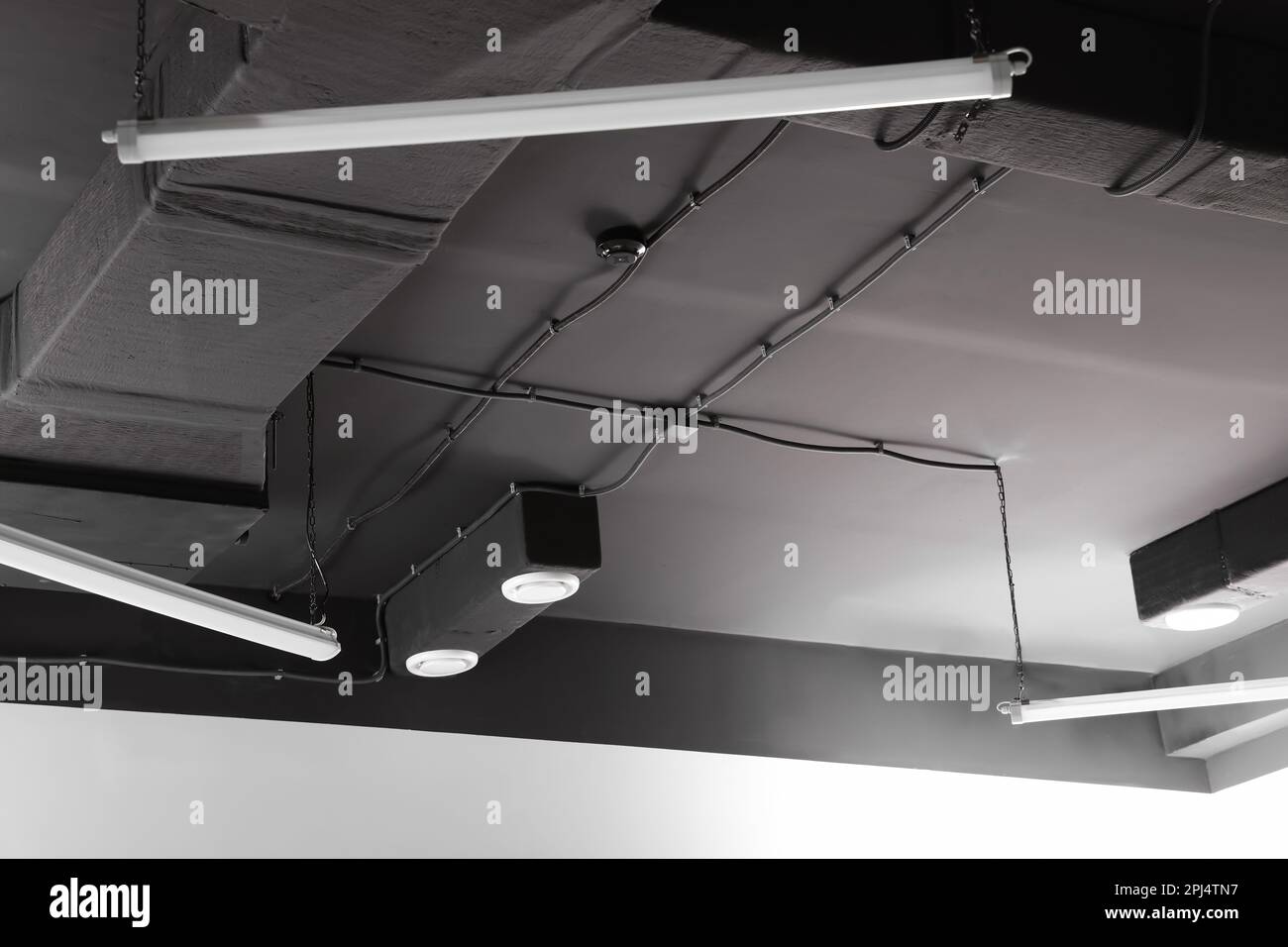Black ceiling with lighting in office room Stock Photo - Alamy