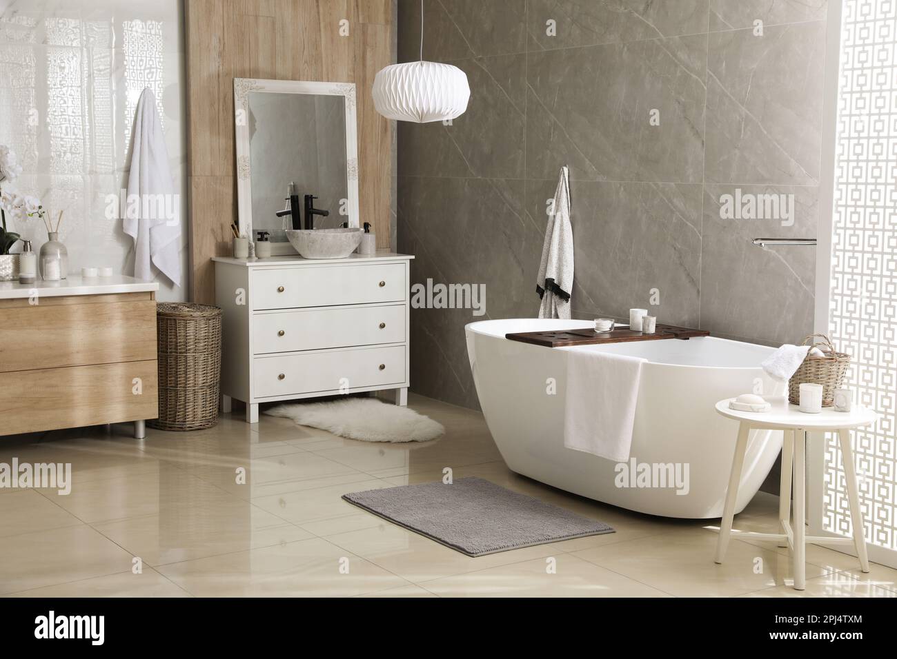Modern white tub and chest of drawers with sink in bathroom. Interior ...