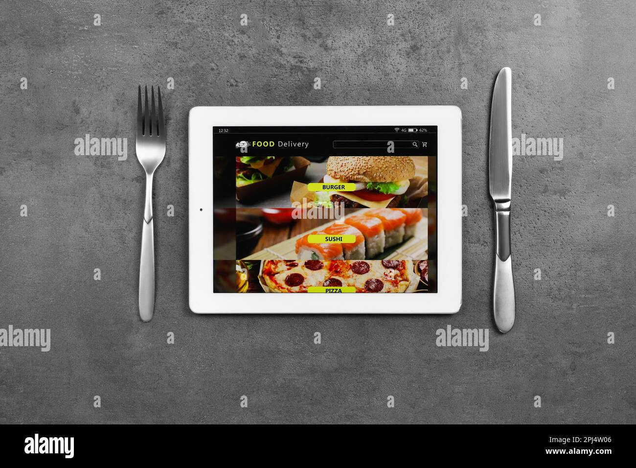 Modern tablet with open page for online food ordering and cutlery on ...