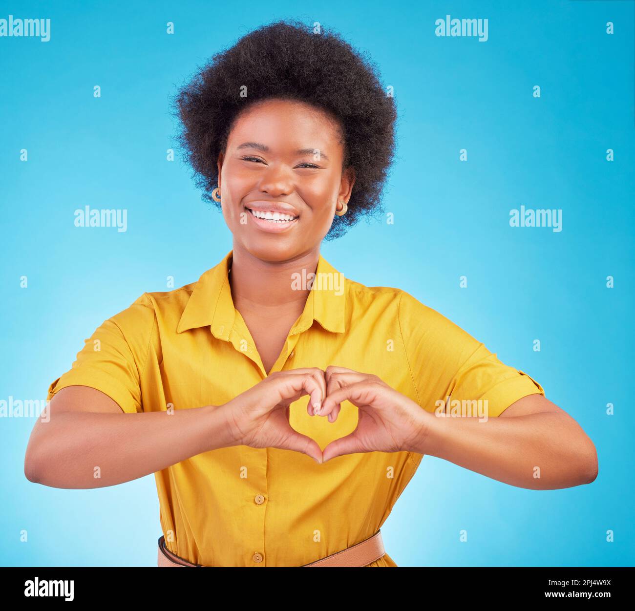 Heart hands, happy black woman and portrait in studio, blue background ...