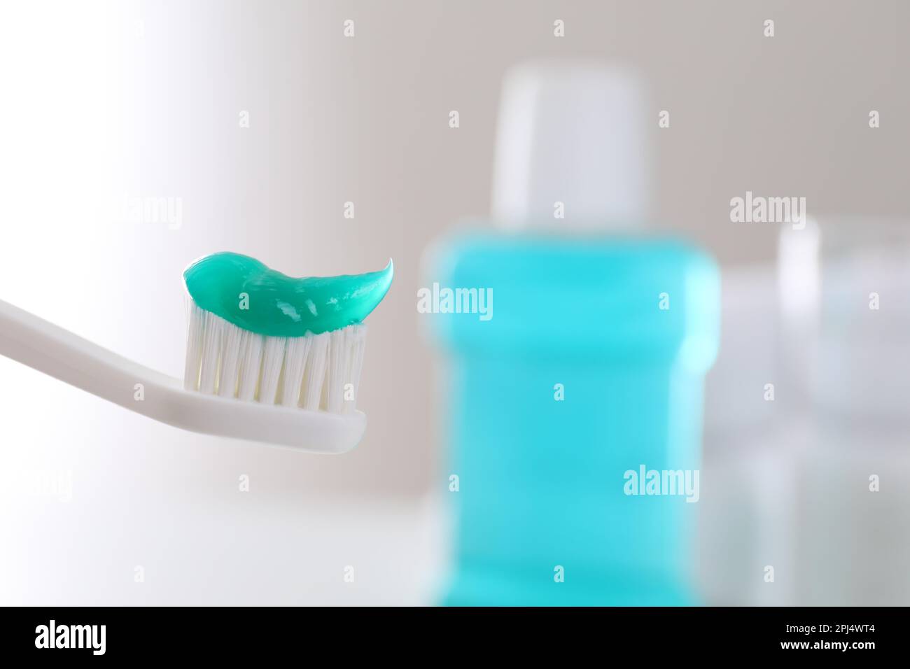 Toothbrush with paste on blurred background, closeup. Space for text ...