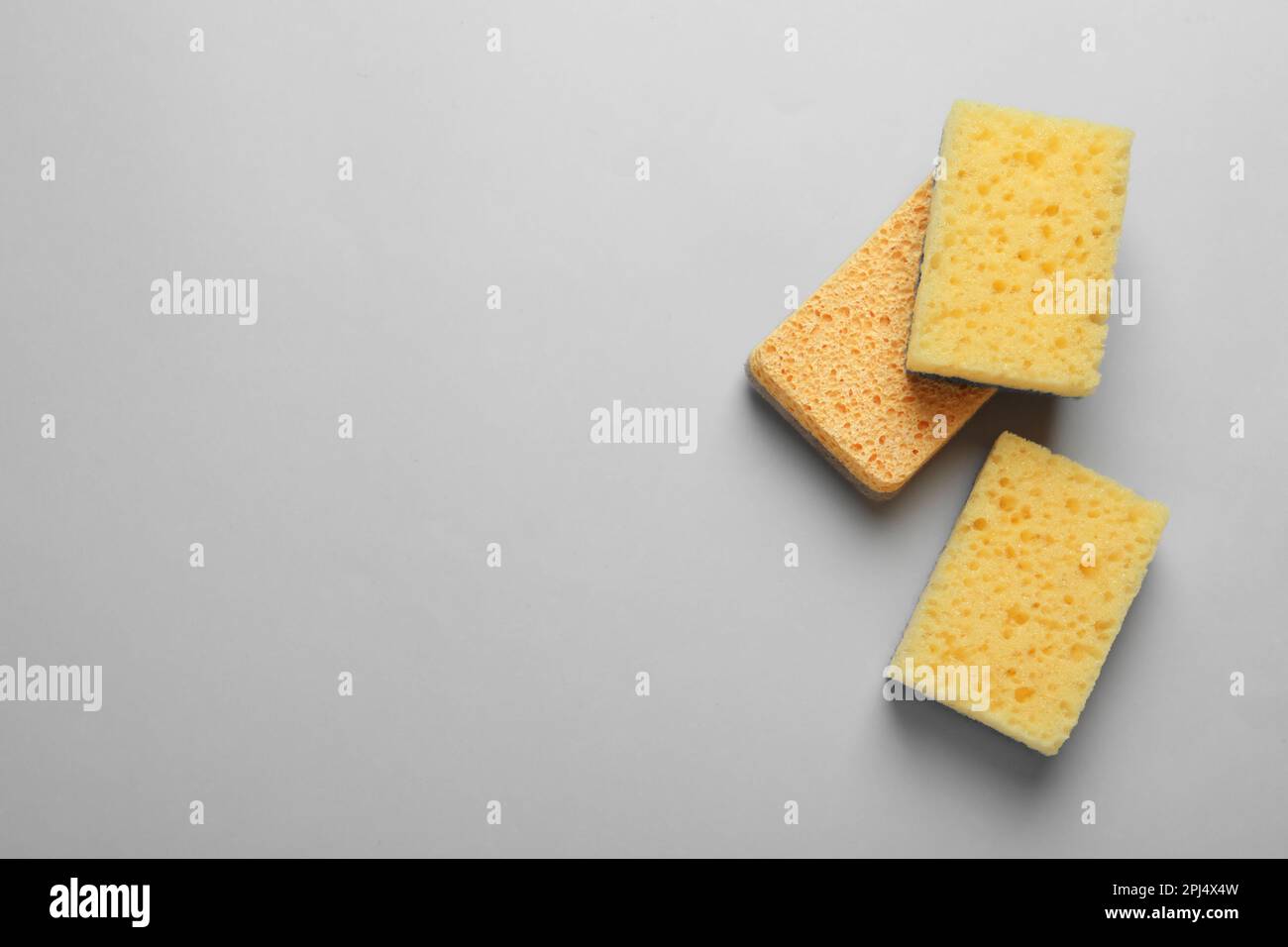 New sponges on light grey background, flat lay. Space for text Stock ...