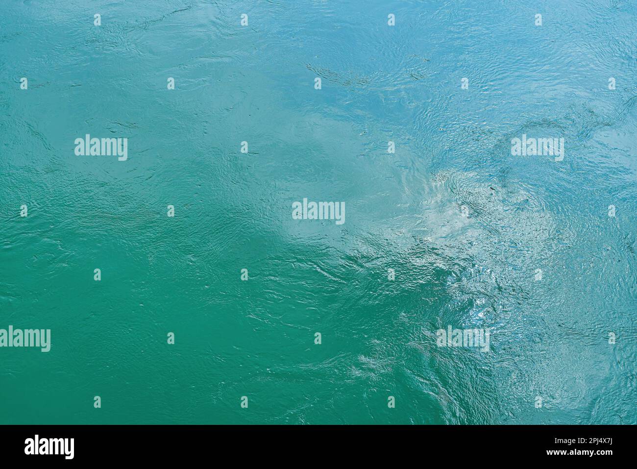 The texture of the waves of turquoise color of fast-flowing water in ...