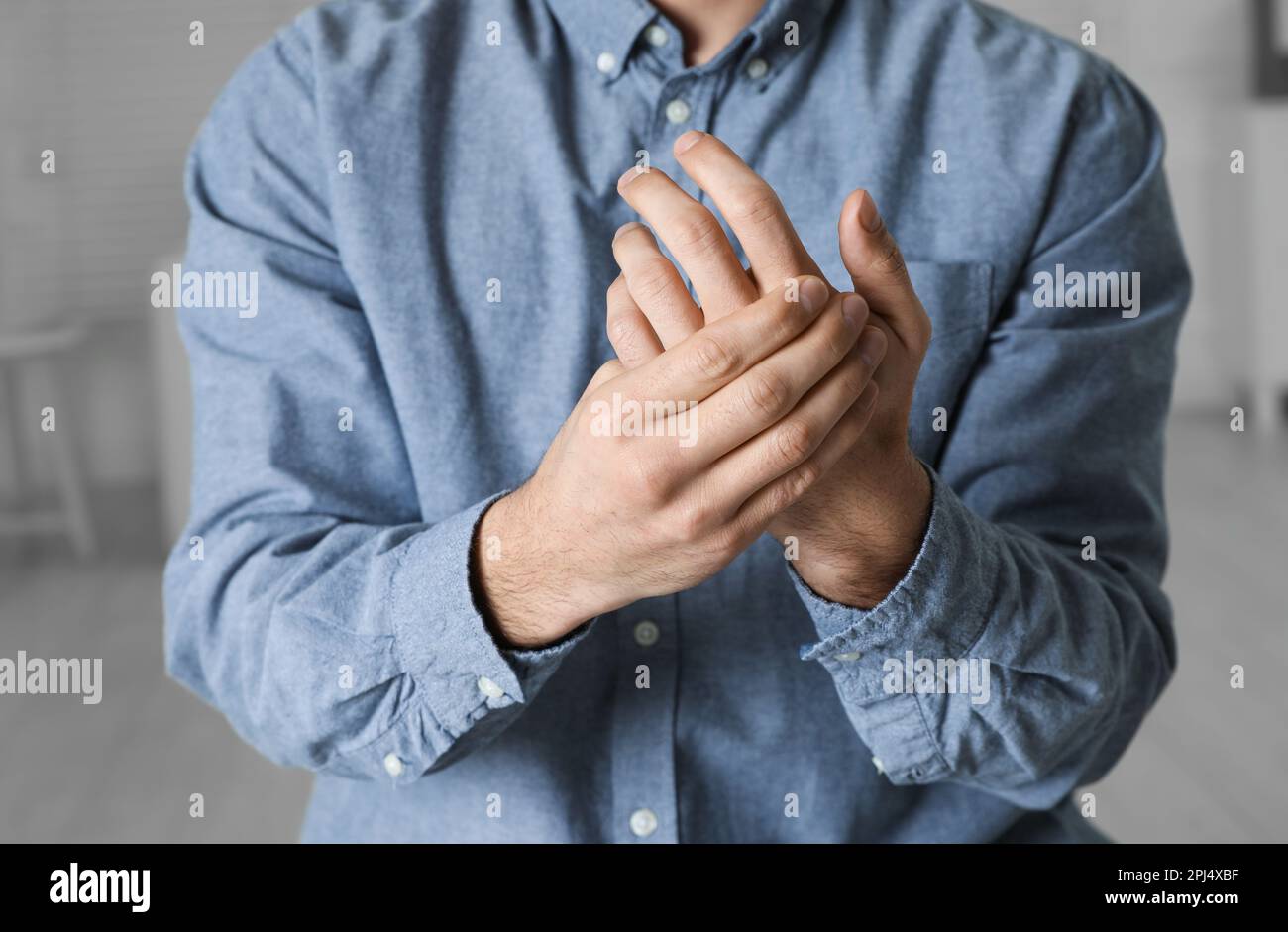 Man suffering from trigger finger at home, closeup Stock Photo - Alamy