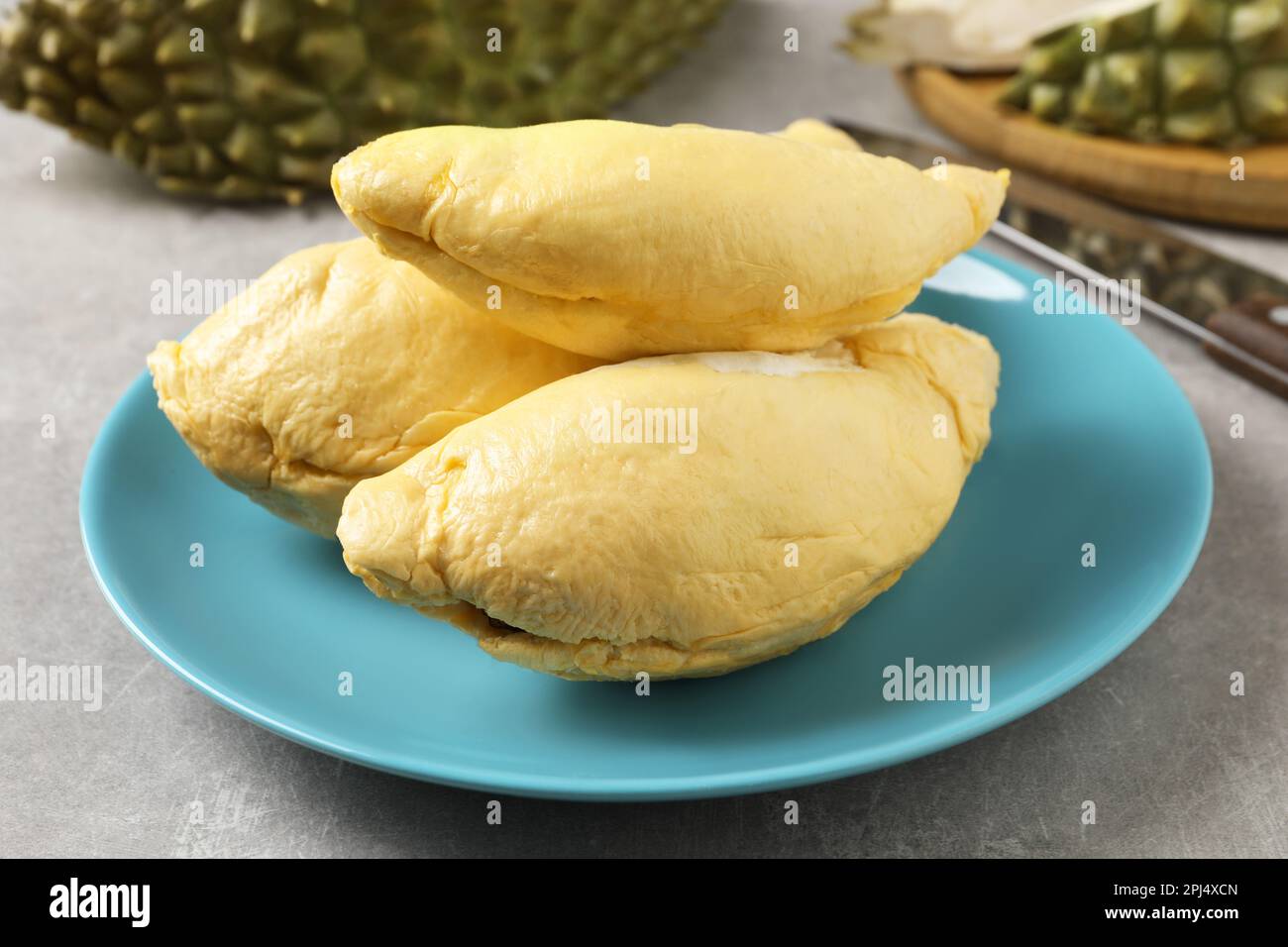 Plate with fresh ripe durian on grey table Stock Photo - Alamy