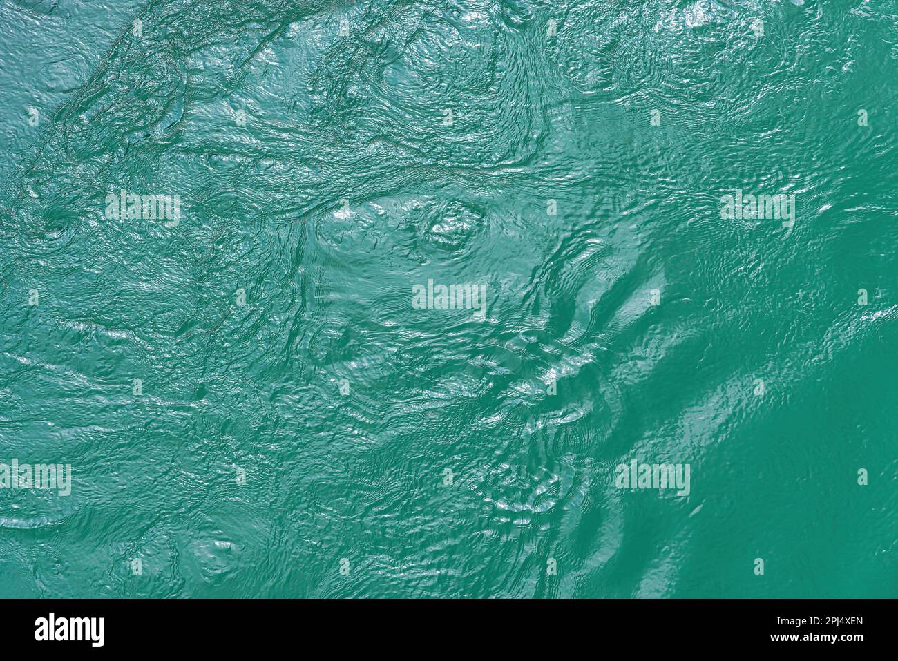 The texture of the waves of turquoise color of fast-flowing water in ...