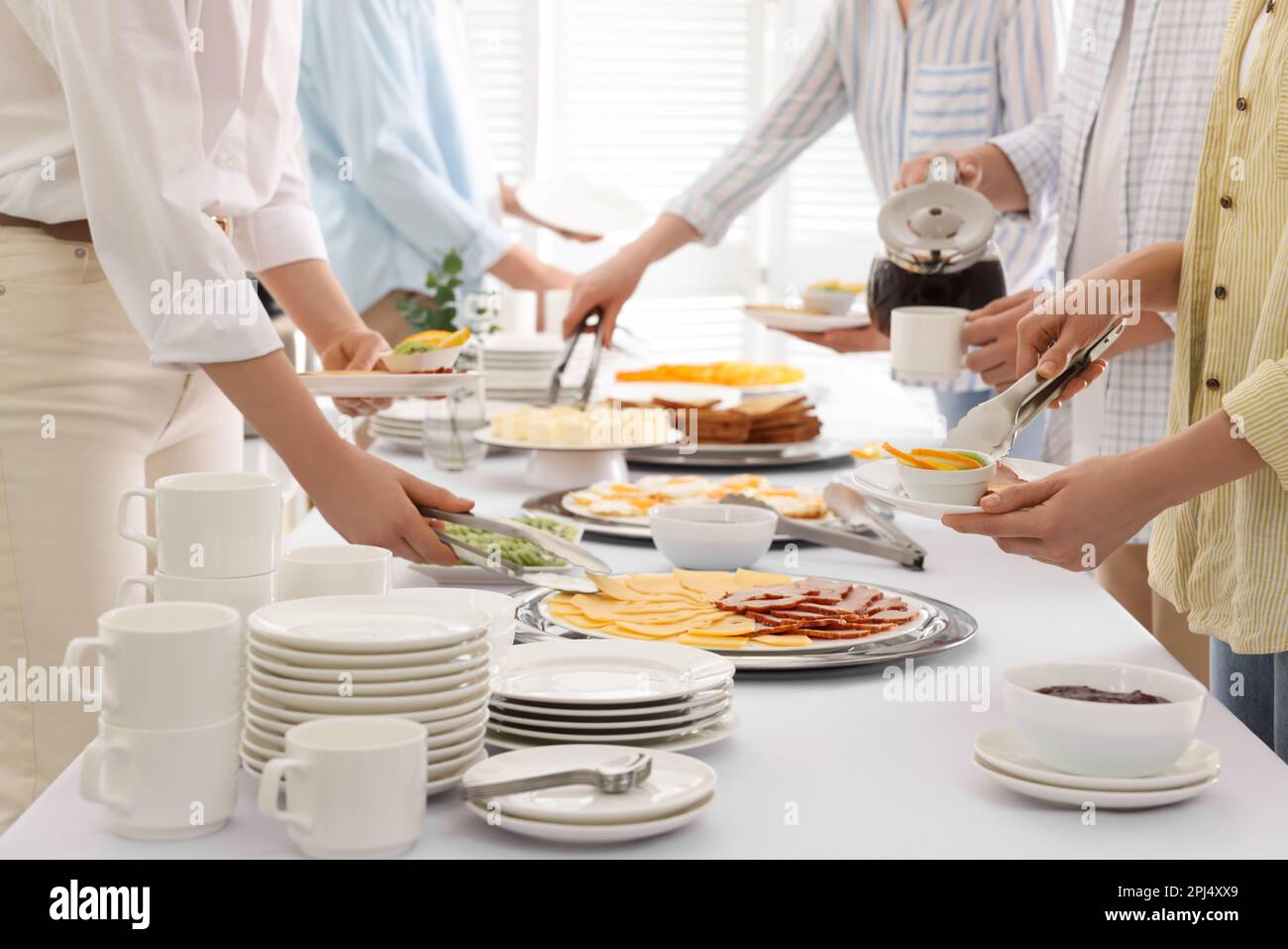 People taking food and pouring coffee during breakfast, closeup. Buffet ...