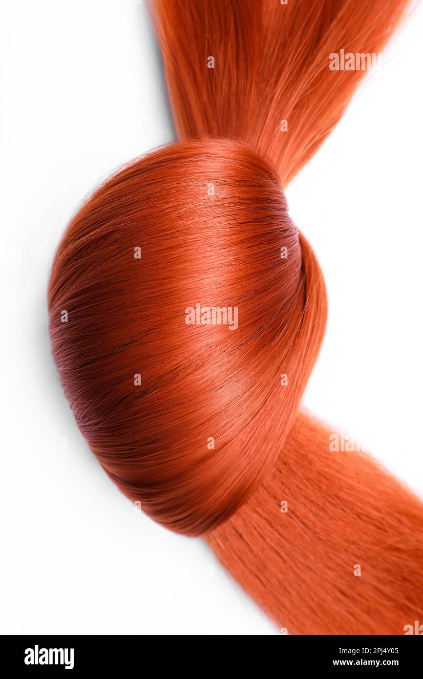 Beautiful strand of red hair tied in knot on white background, top view ...
