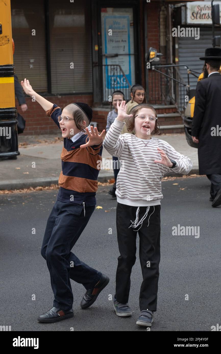 Lively Hasidic yeshiva students have fun during recess on a mild Autumn ...
