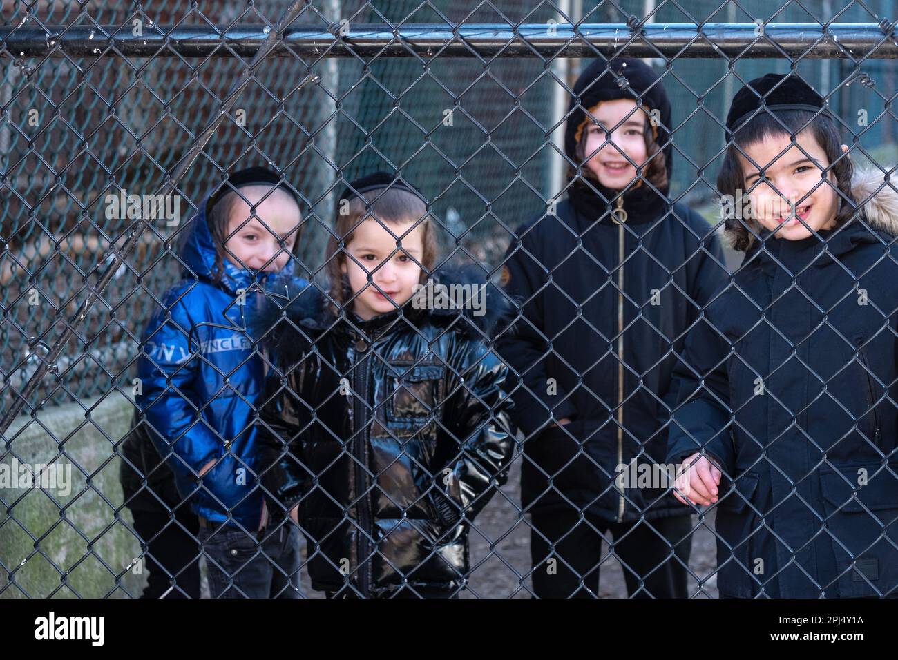 Four Jewish yeshiva boys with long payes smile for a photo during their ...