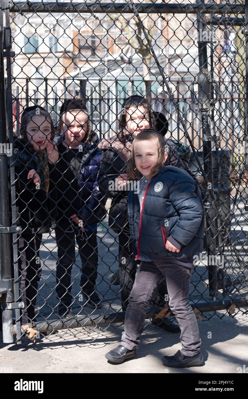 Four Jewish yeshiva boys with long payes smile for a photo during their ...