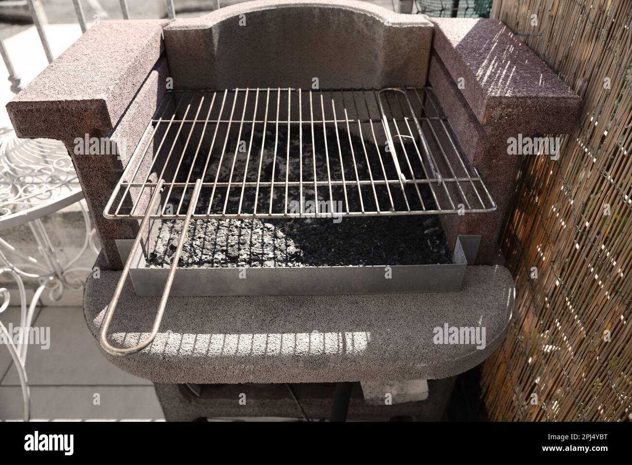 Empty barbecue grill with grid on outdoor terrace Stock Photo - Alamy