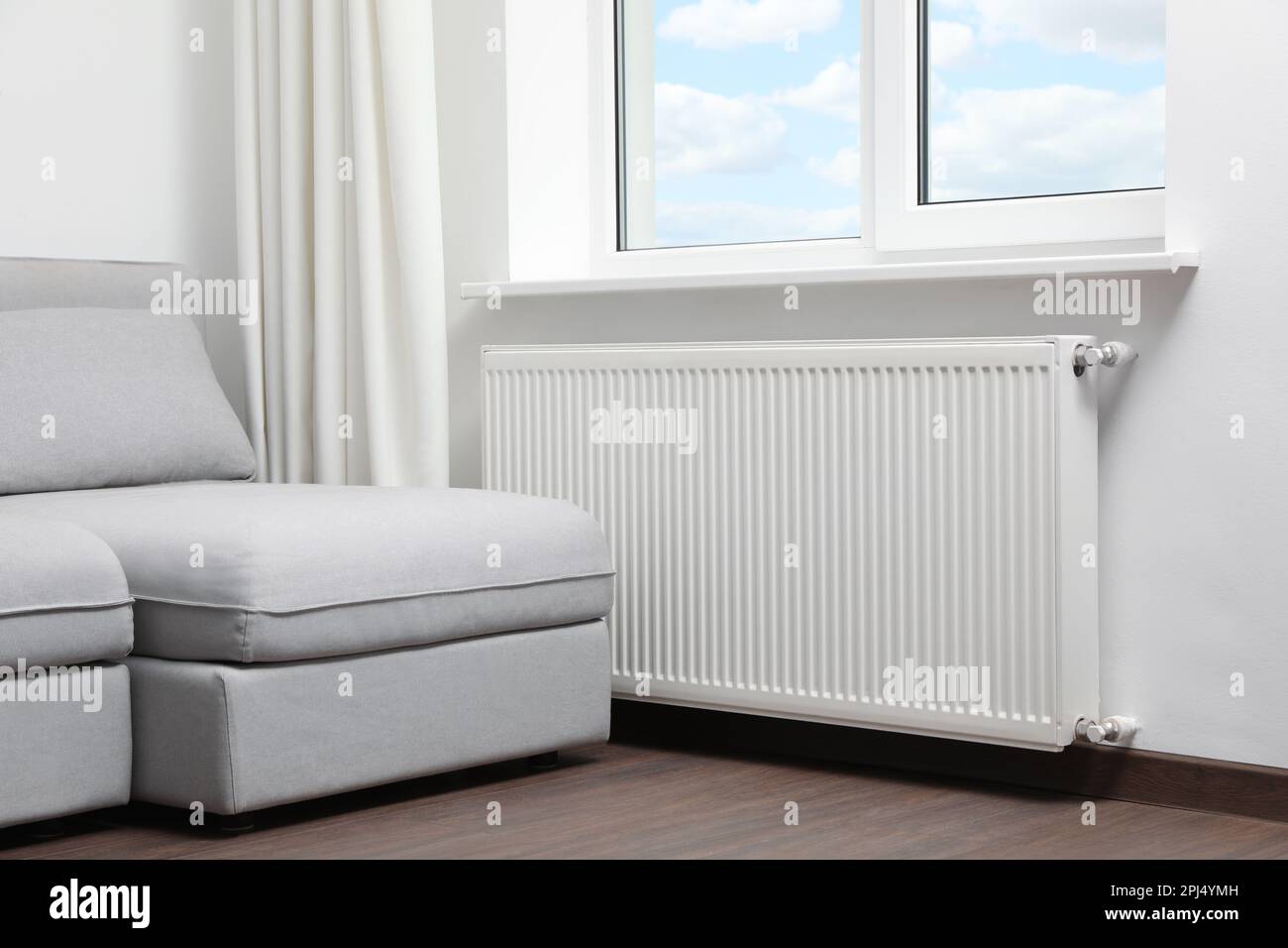 Modern radiator at home. Central heating system Stock Photo - Alamy