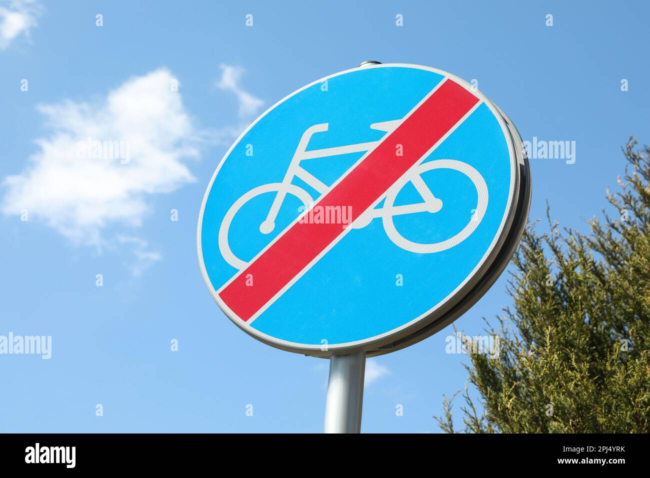 Traffic sign End Of Cycleway against blue sky, low angle view Stock ...