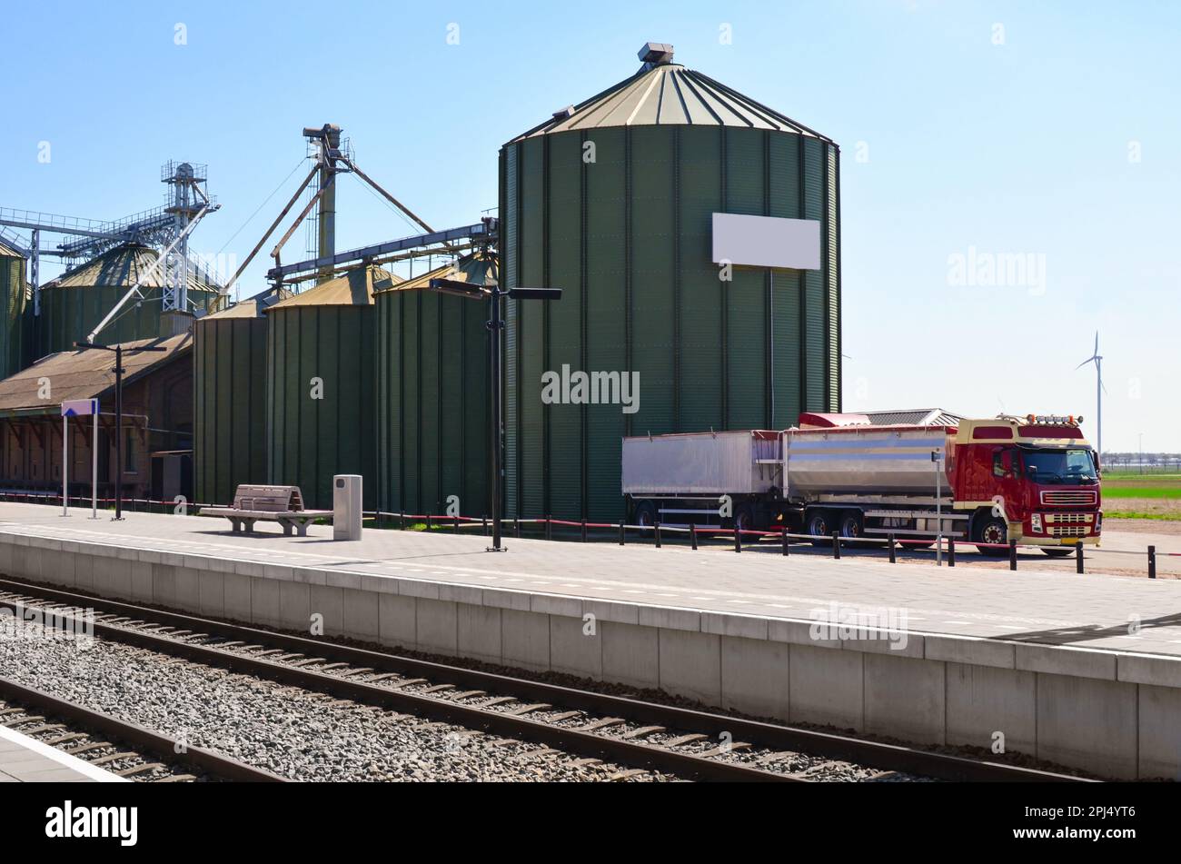 Silos near railway platform on sunny day Stock Photo - Alamy
