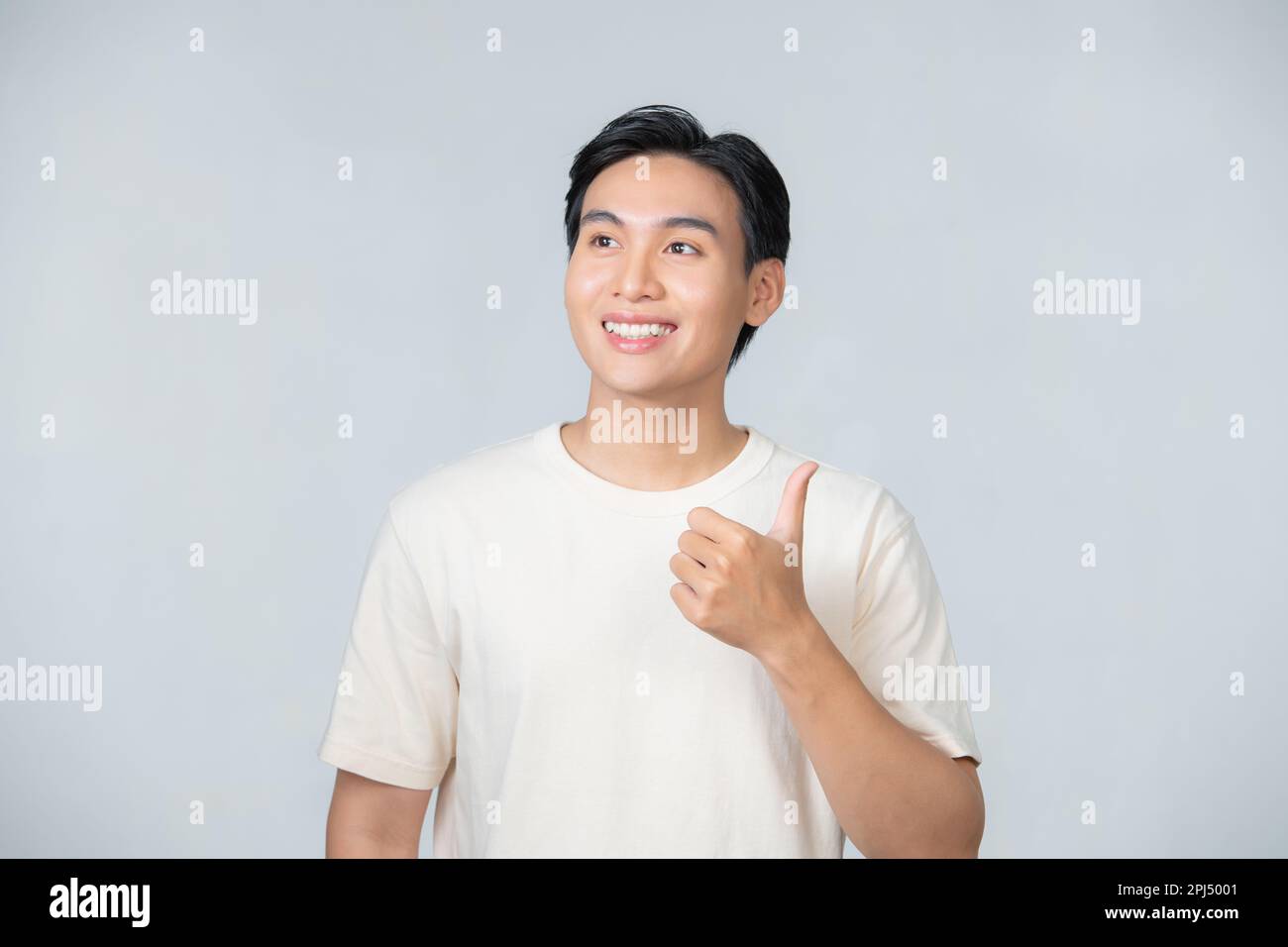 Handsome happy man smiling and thumbs up, isolated on white background ...